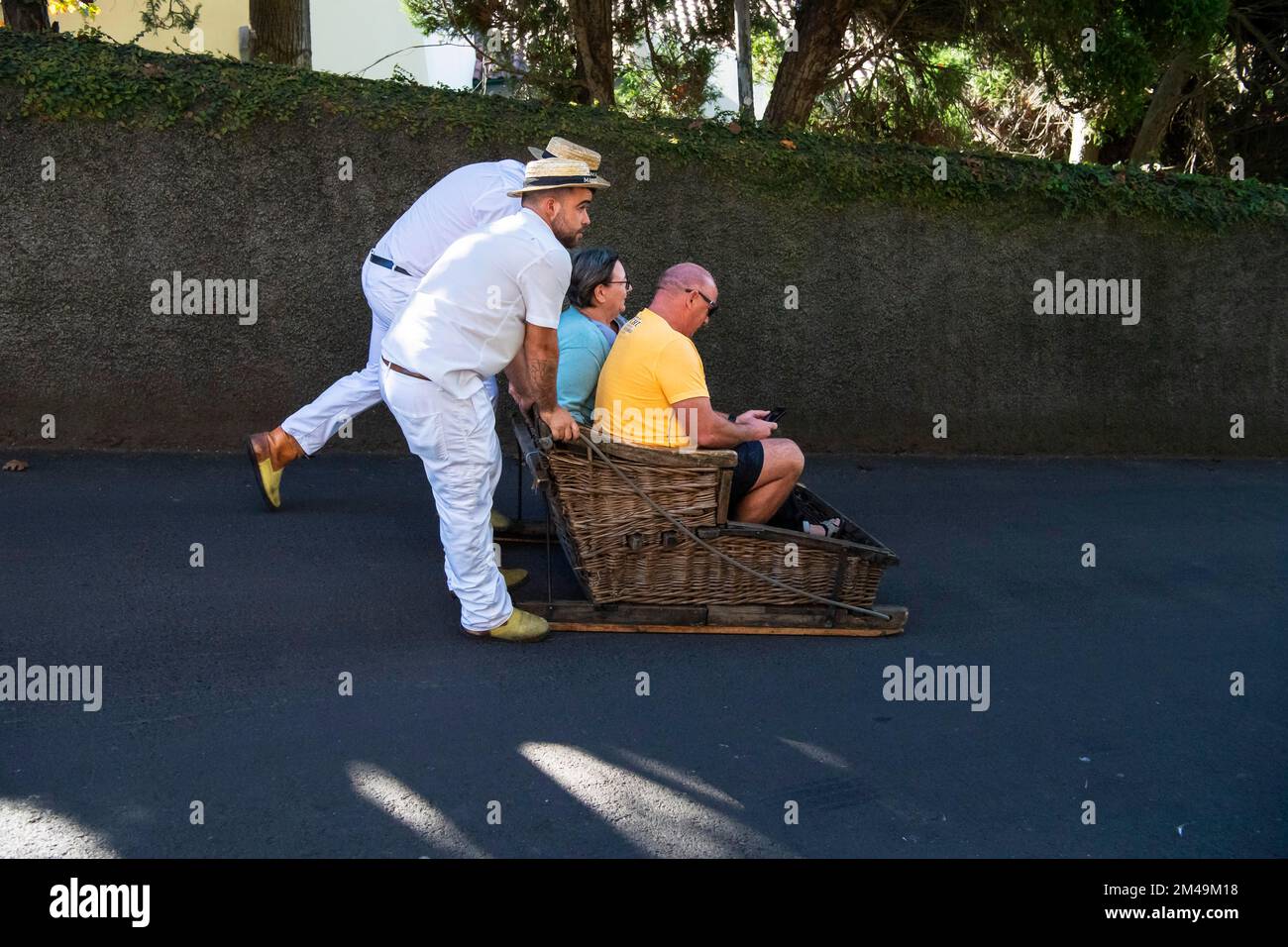 Basket sledders take tourists downhill in the Monte district of Funchal ...