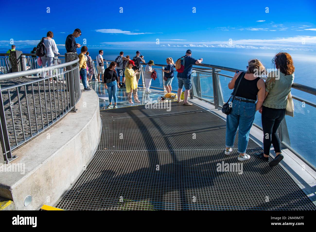 Tourists look at the view from the glass-bottom skywalk, Cabo Girao ...