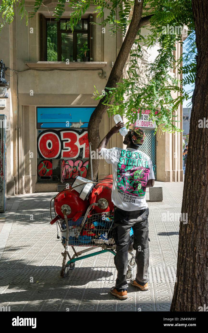Man collects small metal in shopping trolley, Barcelona, Catalonia ...