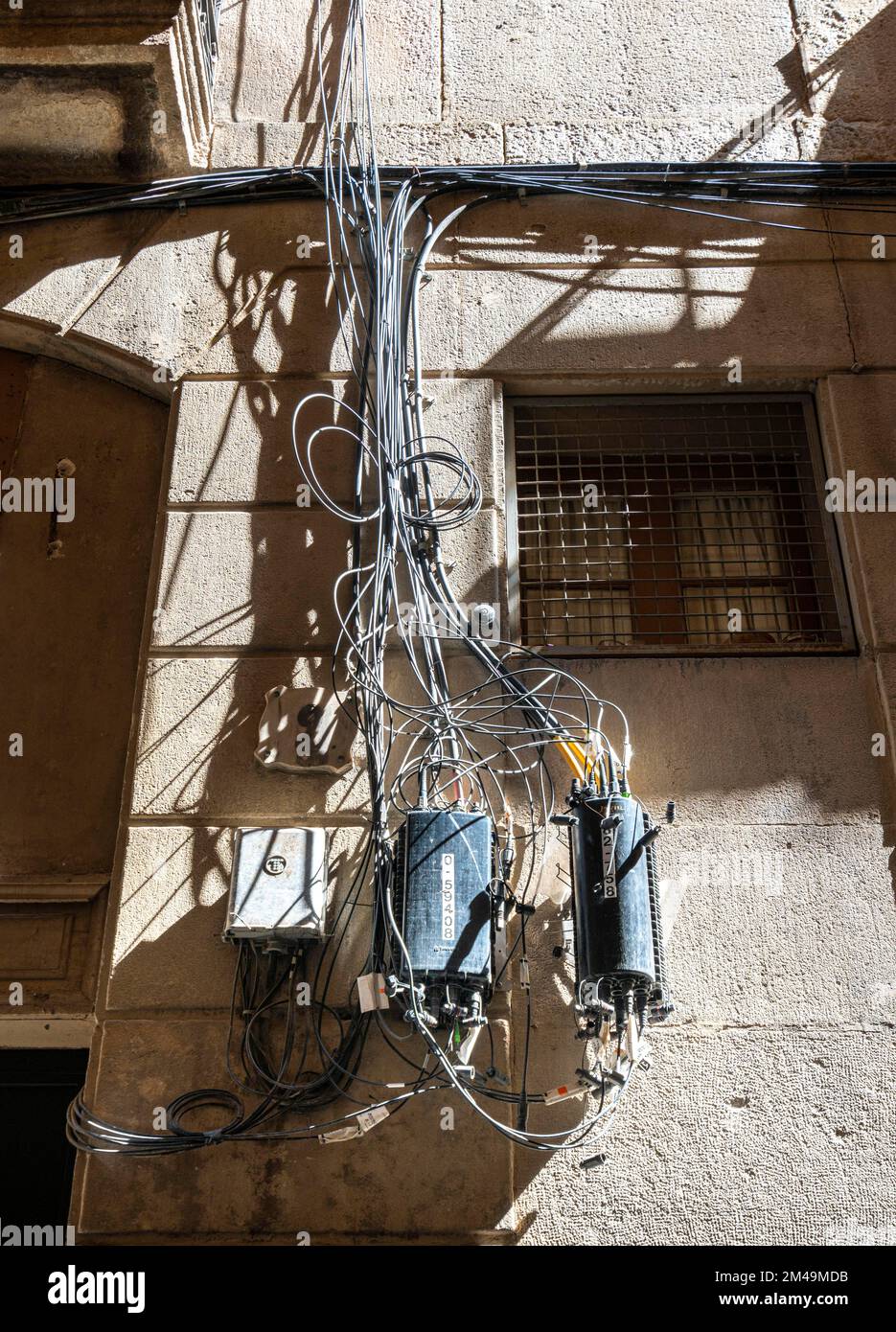 Power lines and cables on the house facade, Barcelona, Catalonia, Spain ...