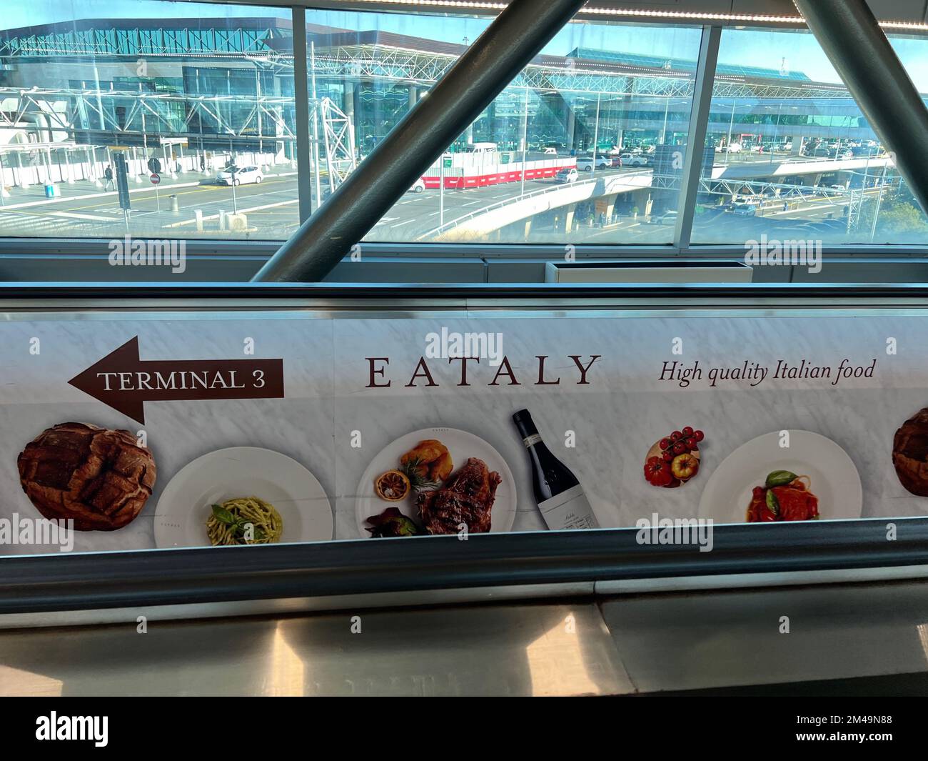 A sign for Eataly directs passengers to its store at Fiumicino airport ...