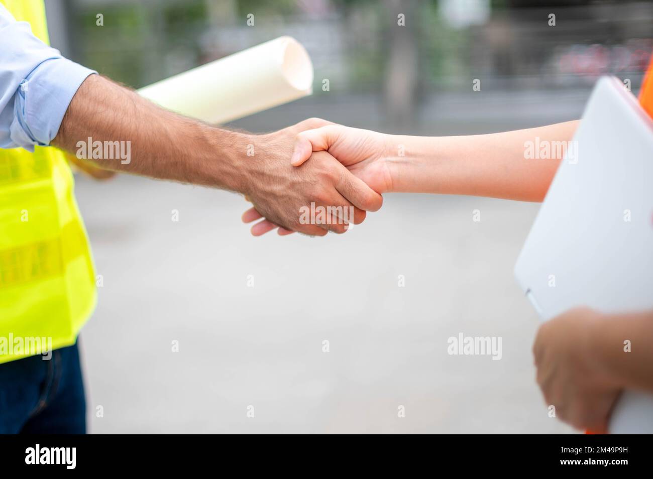 Two engineers shaking hands with deals and success agreements at the ...