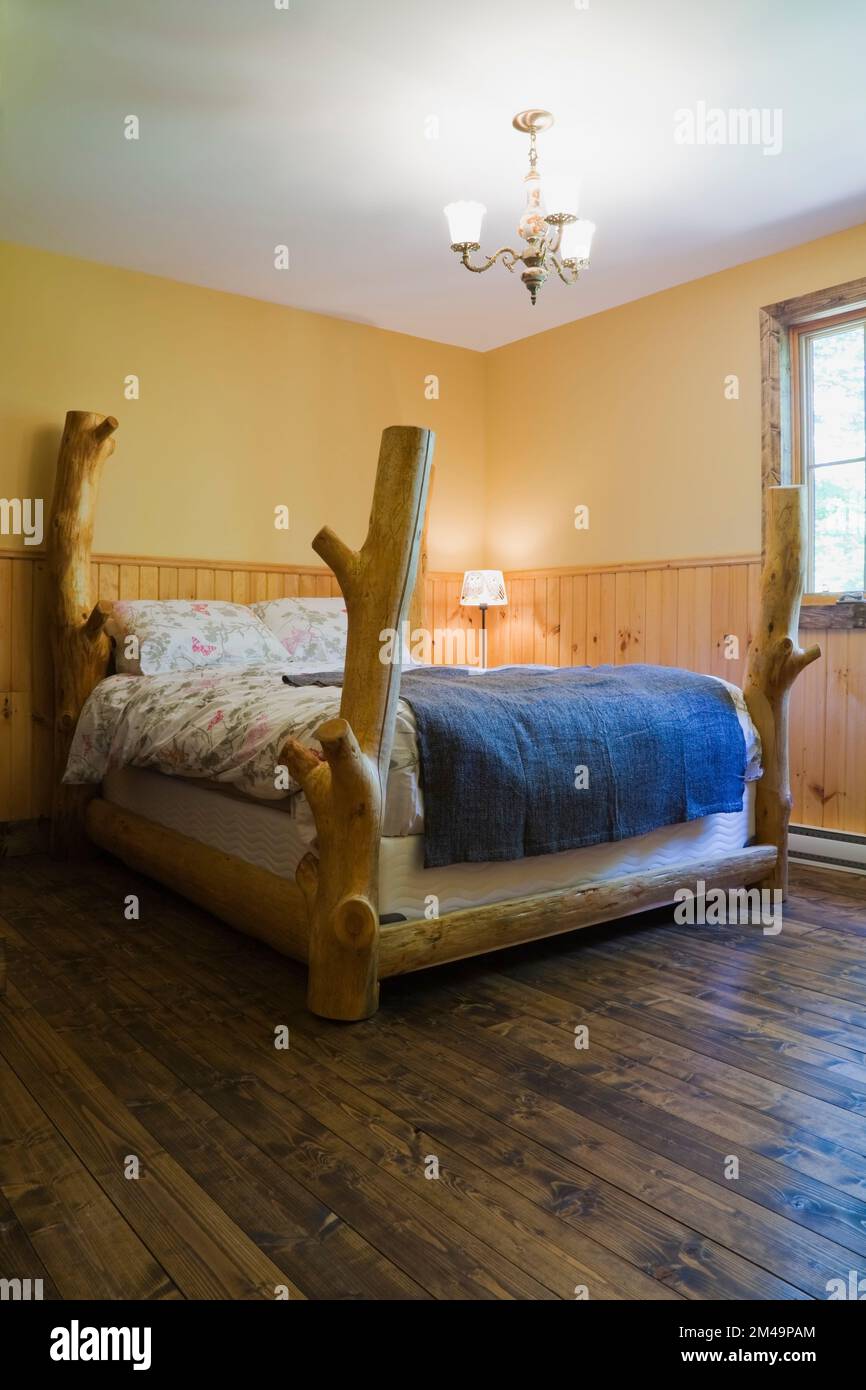 Rustic four poster bed in upstairs guest bedroom with nuanced brown ...