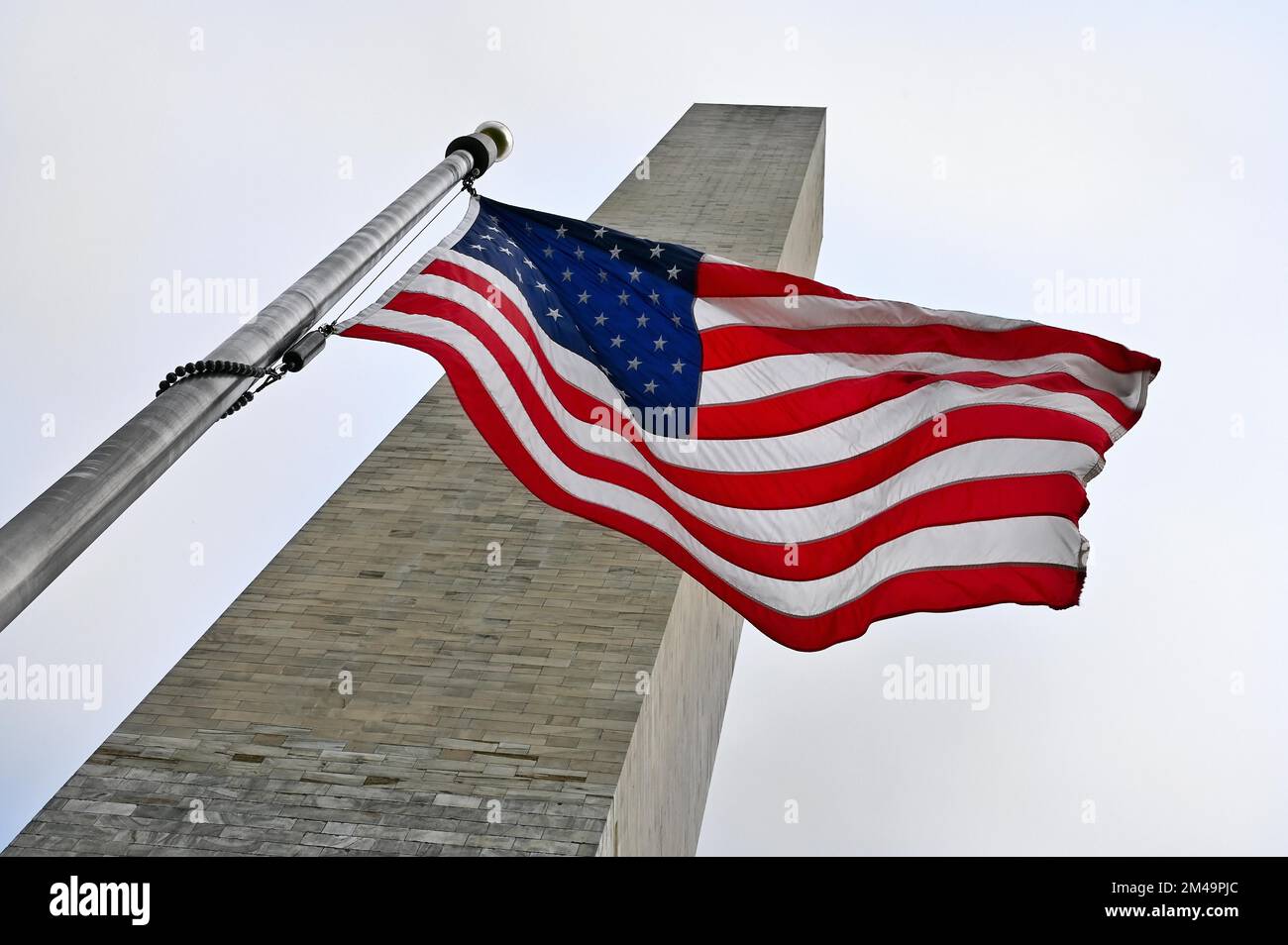 American flag in front of the Washington Monument on the National Mall ...