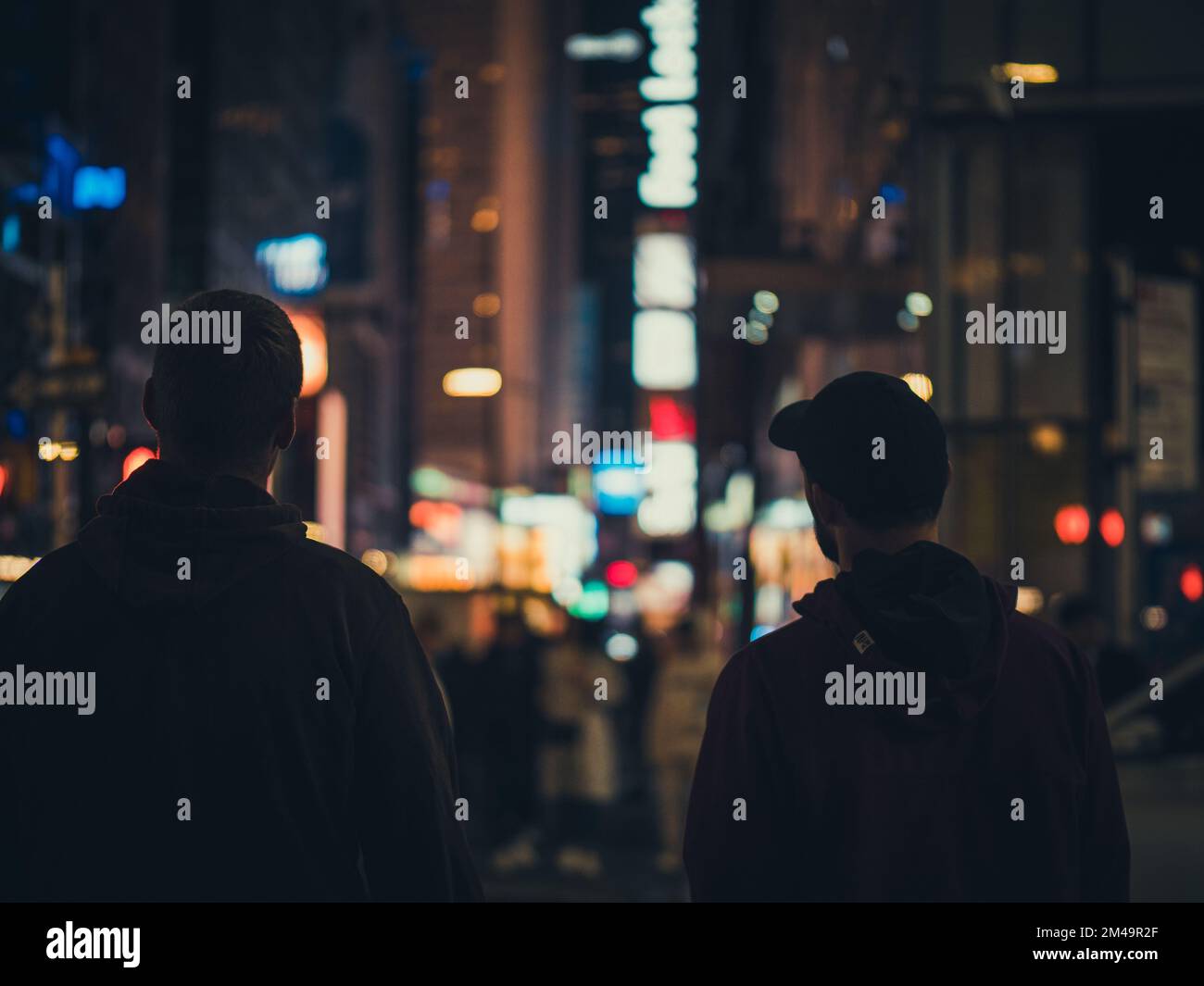 The two men in Times Square at night. New York, USA Stock Photo - Alamy