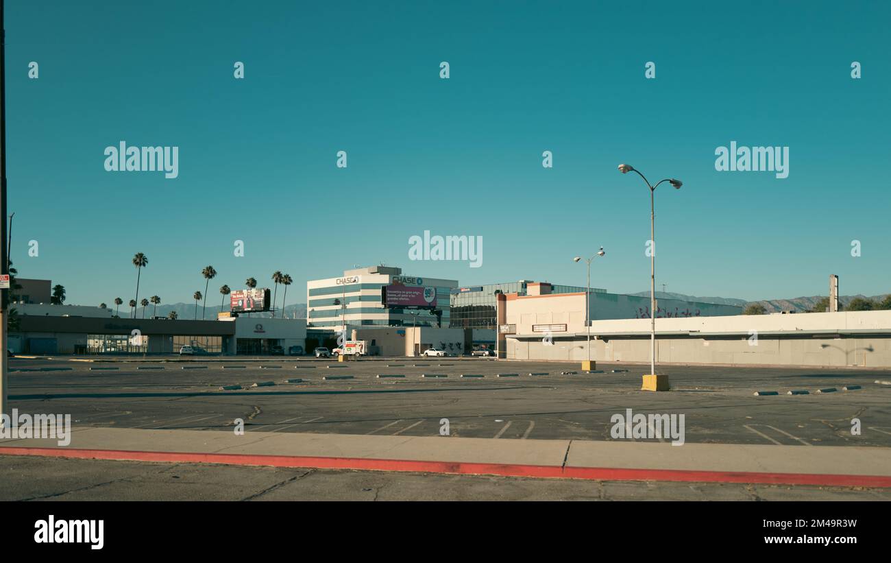 A bright blue sky over an abandoned shopping mall parking area Stock ...