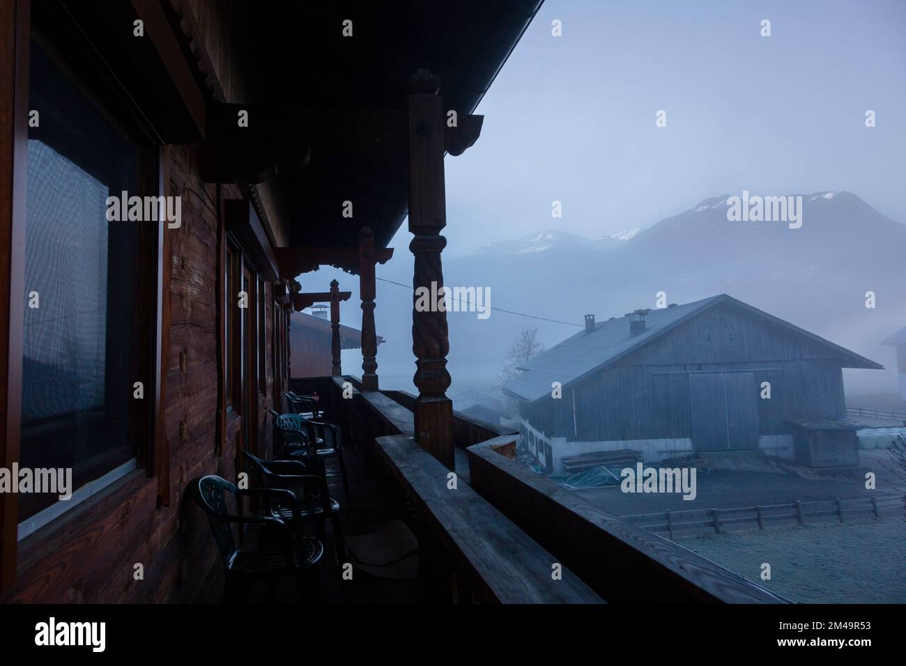 a farm in the Austrian mountains is covered in thick fog, Tyrol, Alps ...