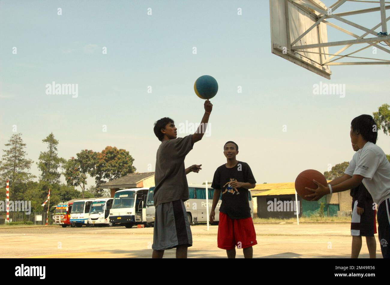 Teenagers playing basketball at a basketball field that occasionally ...