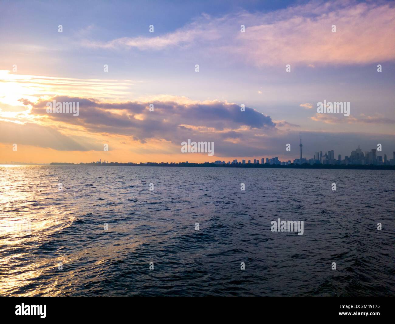Autumn sunset view across Toronto Harbour of Lake Ontario with foggy ...
