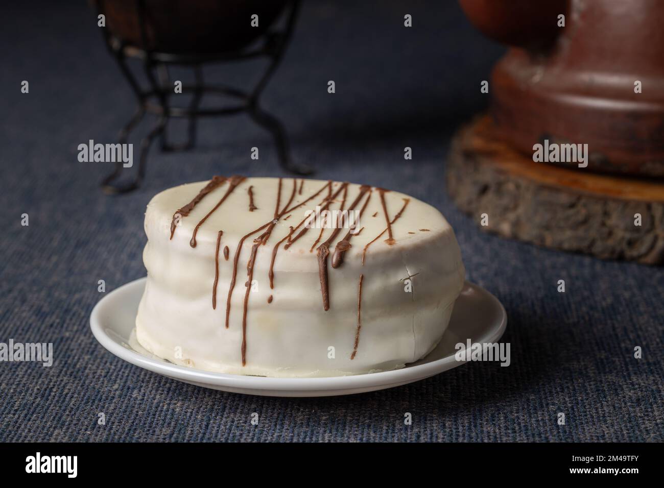 White chocolate alfajor, typical candy in Argentina, on dark background ...