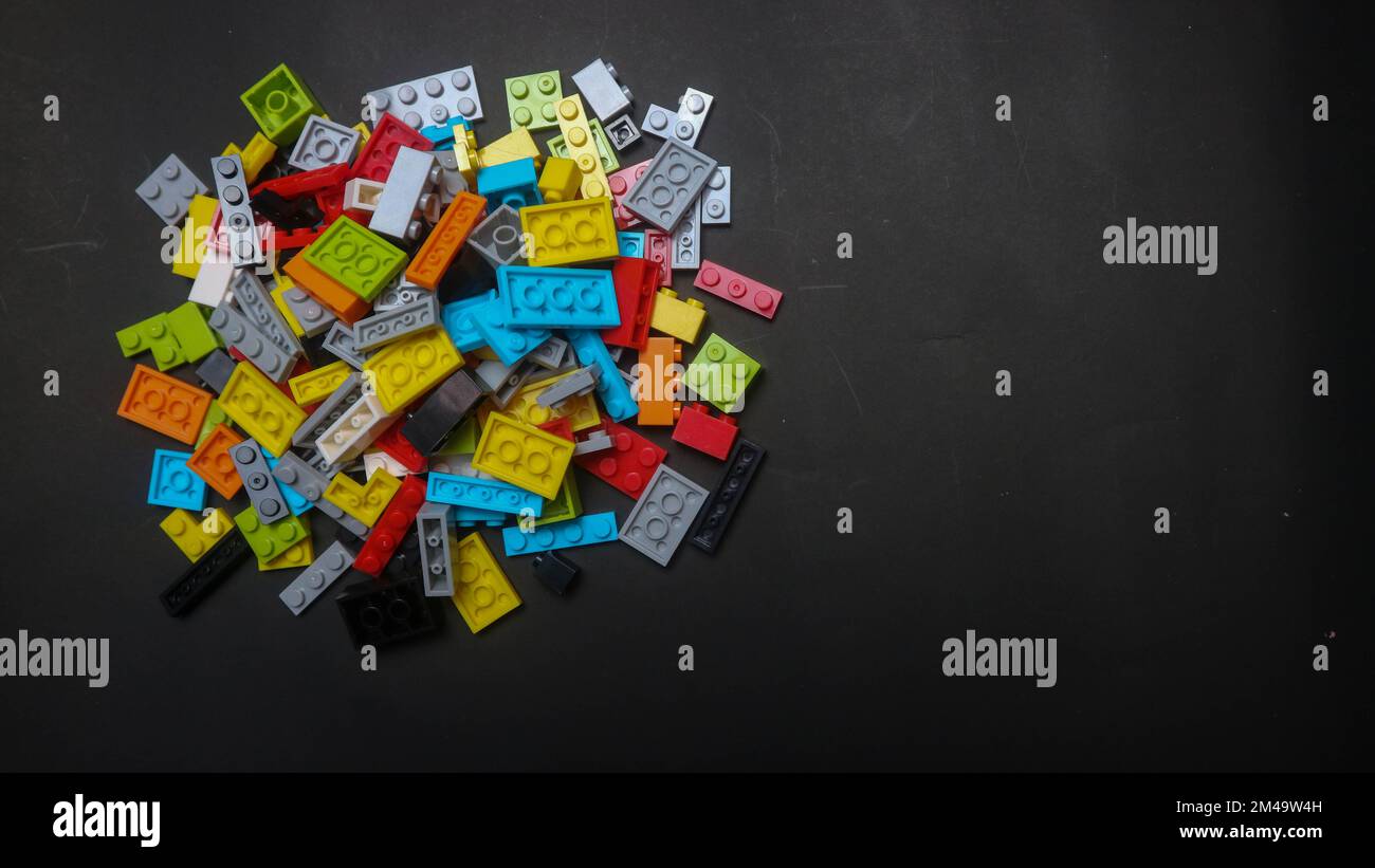 Plastic toy blocks on black background Stock Photo - Alamy