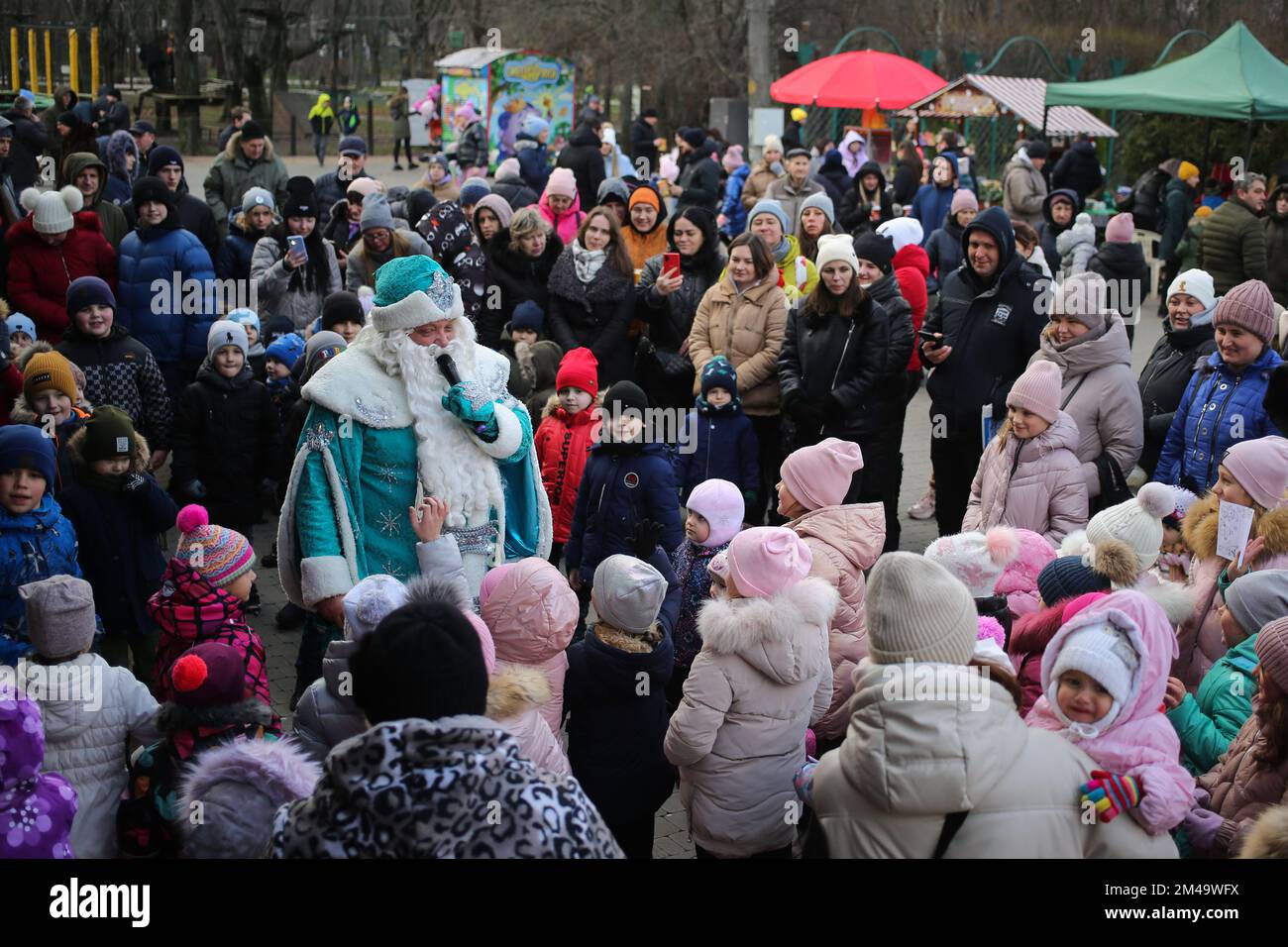 An animator dressed as St. Nicholas interacts with the children on St ...
