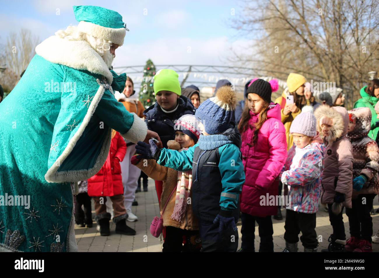 An animator dressed as St. Nicholas interacts with the children on St ...