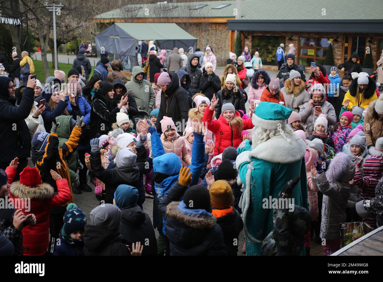 An animator dressed as St. Nicholas interacts with the children on St ...