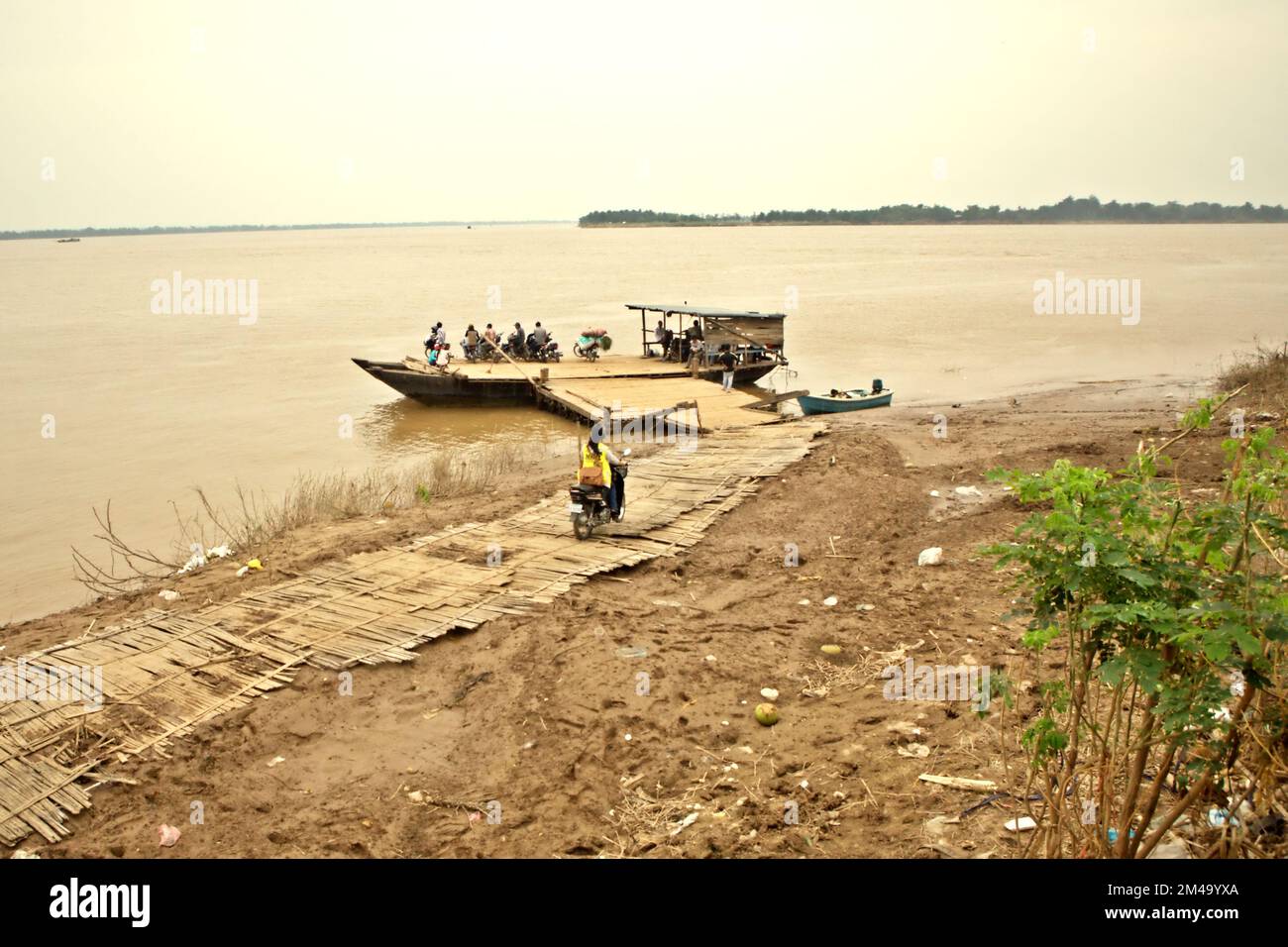 A ferry boat waiting for passengers to board, at a river-crossing port ...