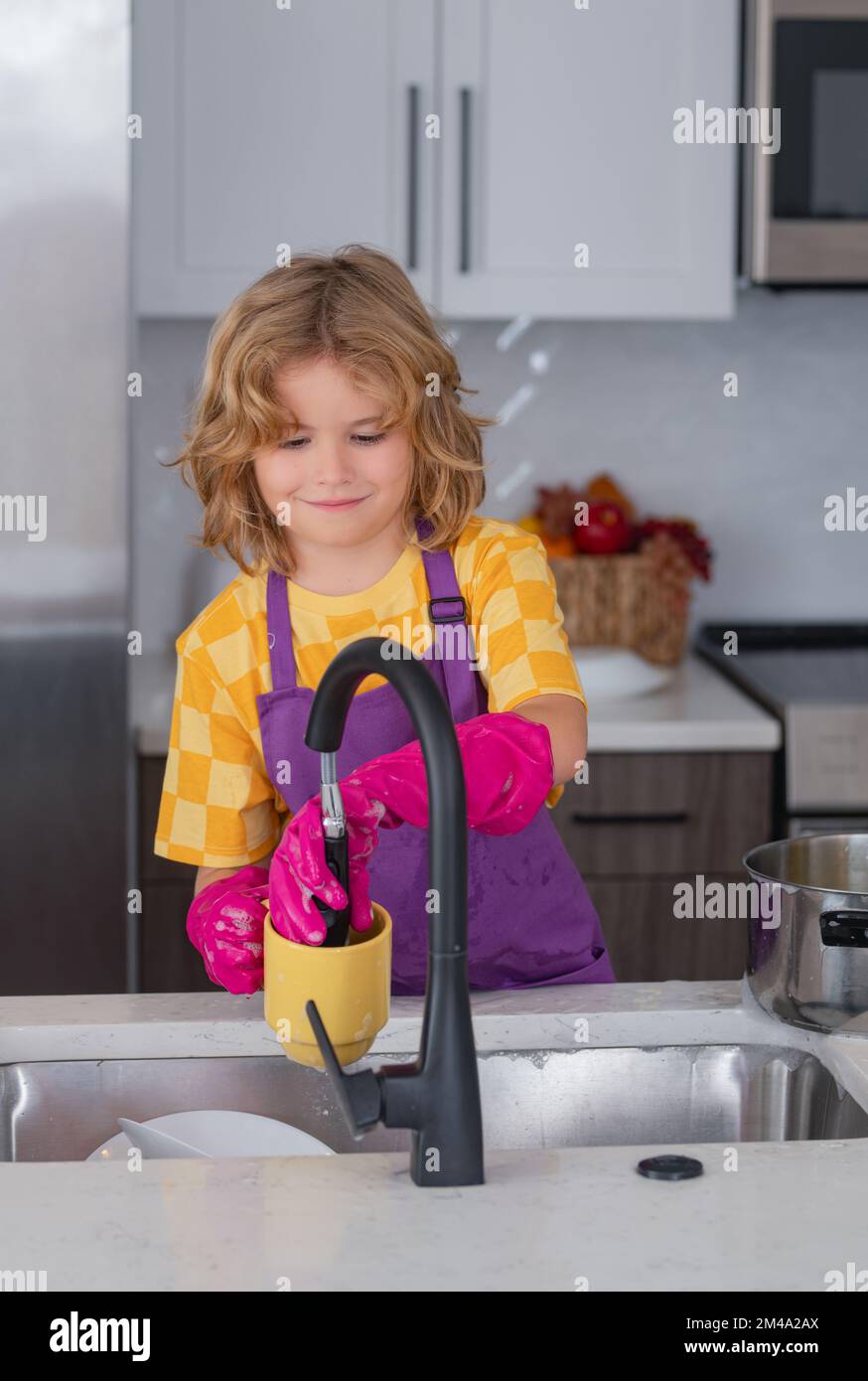 Dish washing concept. Little housekeeper. Child washing and wiping ...