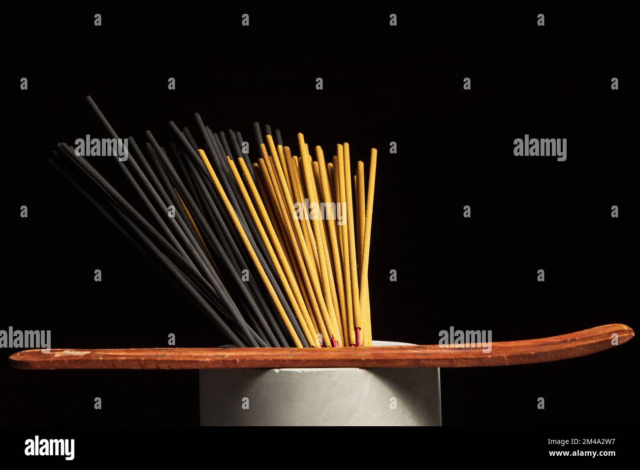 Many different incense sticks with wooden stand Stock Photo - Alamy