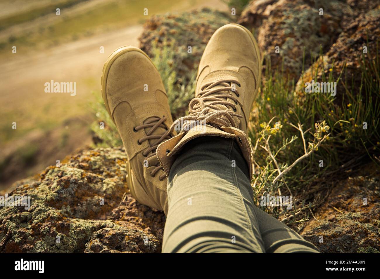 High laced hiking shoes on female legs in rocky terrain safari style ...