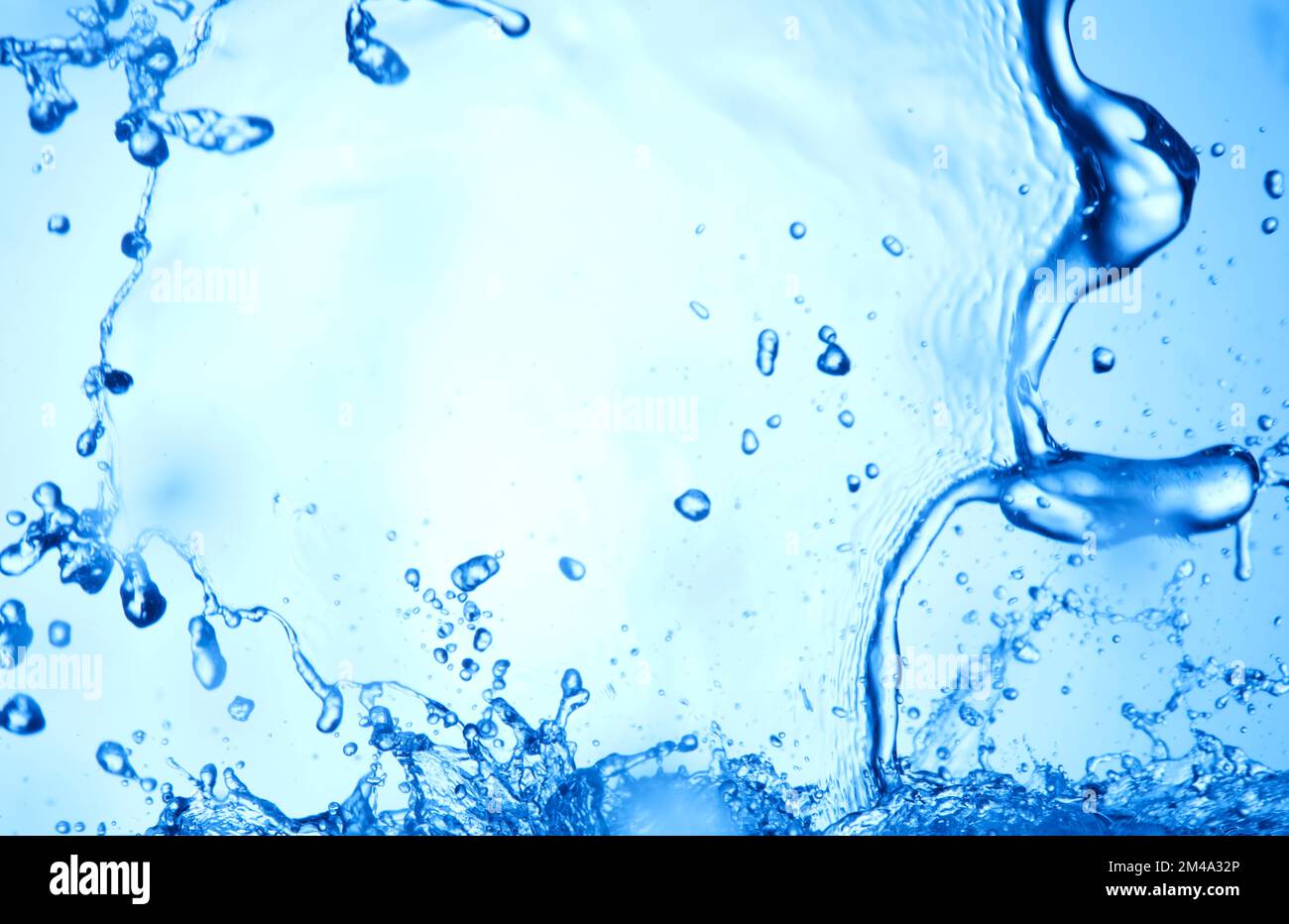 Drops of water falling into deep blue water Stock Photo - Alamy