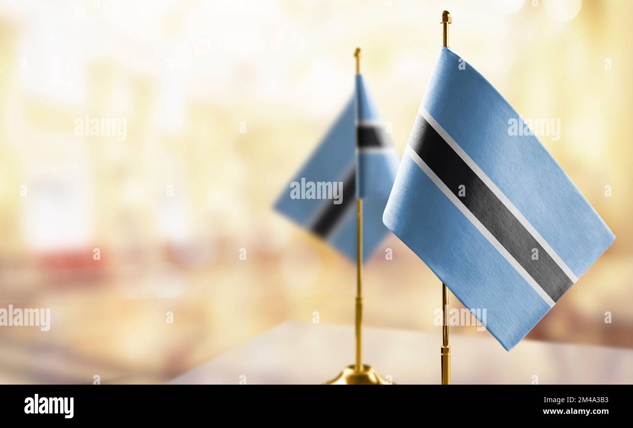 Small flags of the Botswana on an abstract blurry background Stock ...