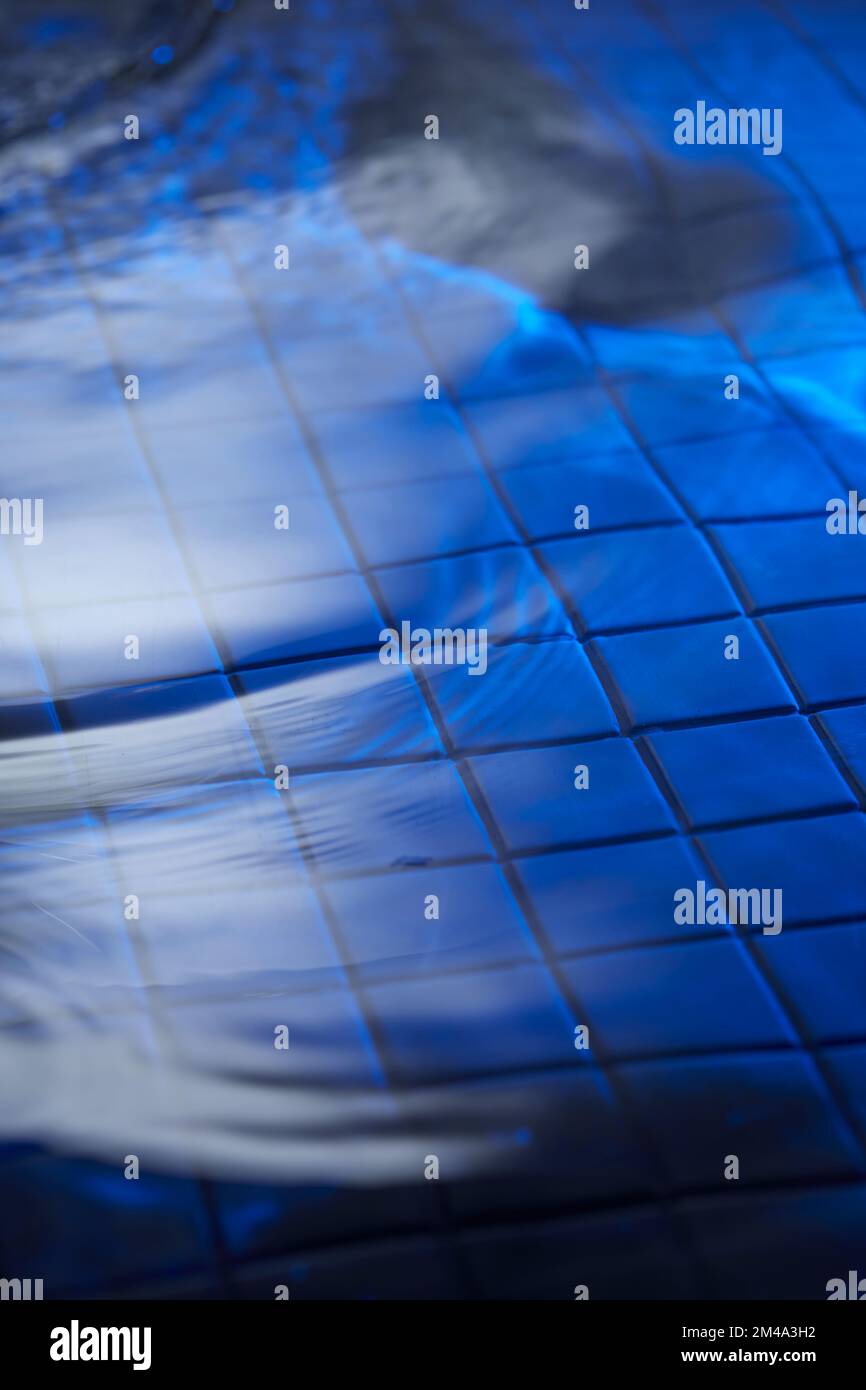 Drops of water falling into deep blue water Stock Photo - Alamy