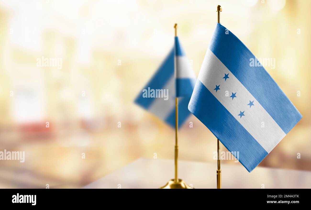 Small flags of the Honduras on an abstract blurry background Stock ...