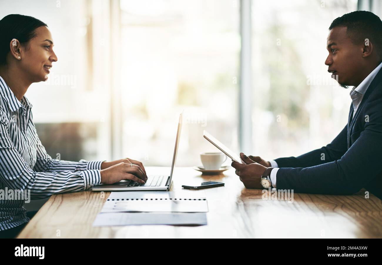 Planning their next business move. two businesspeople using digital ...