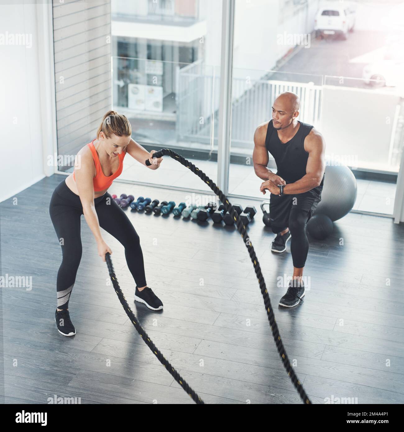 Hes her biggest motivation. a young woman working out with her personal ...
