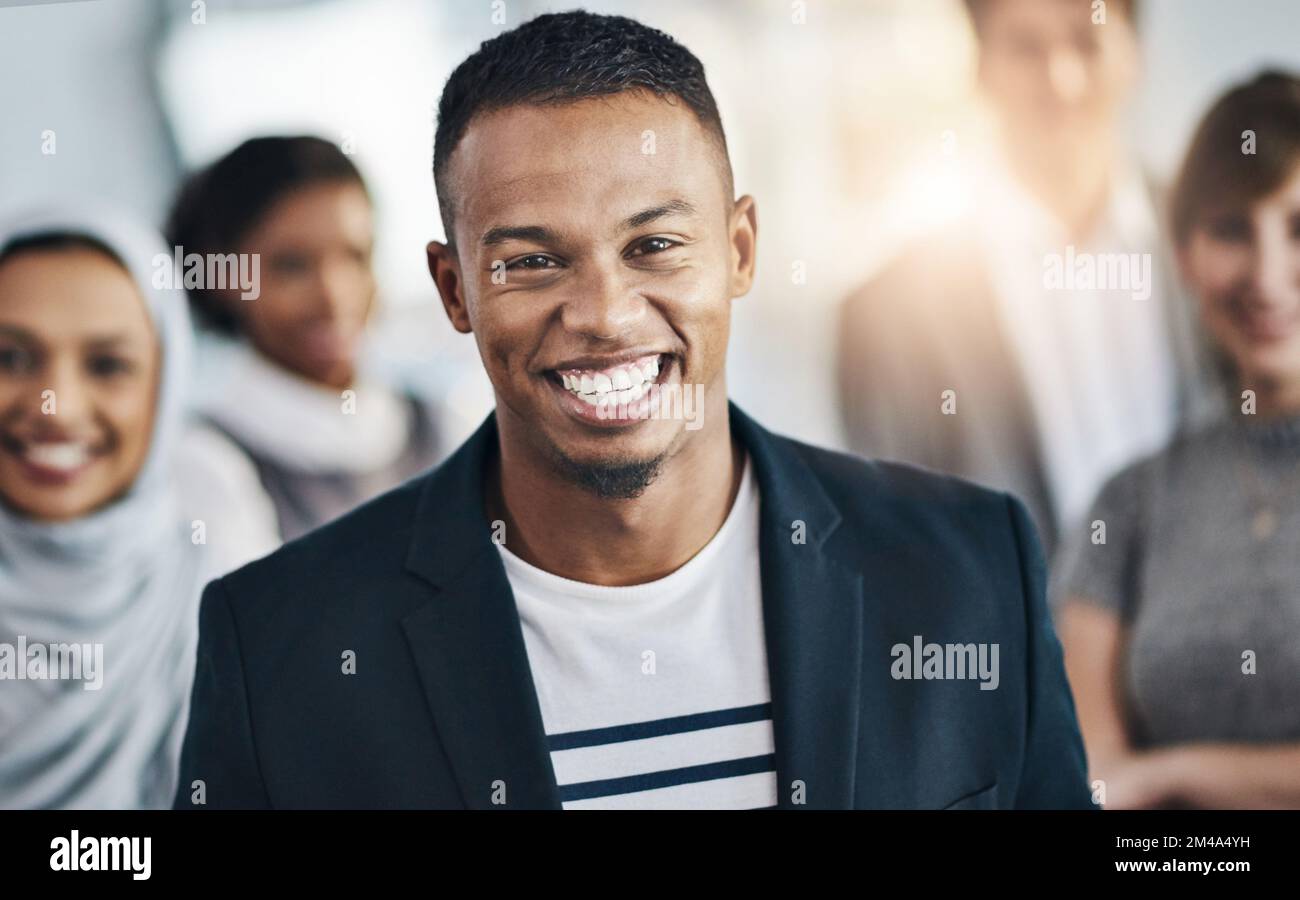 Striving to success. Portrait of a cheerful young businessman standing ...