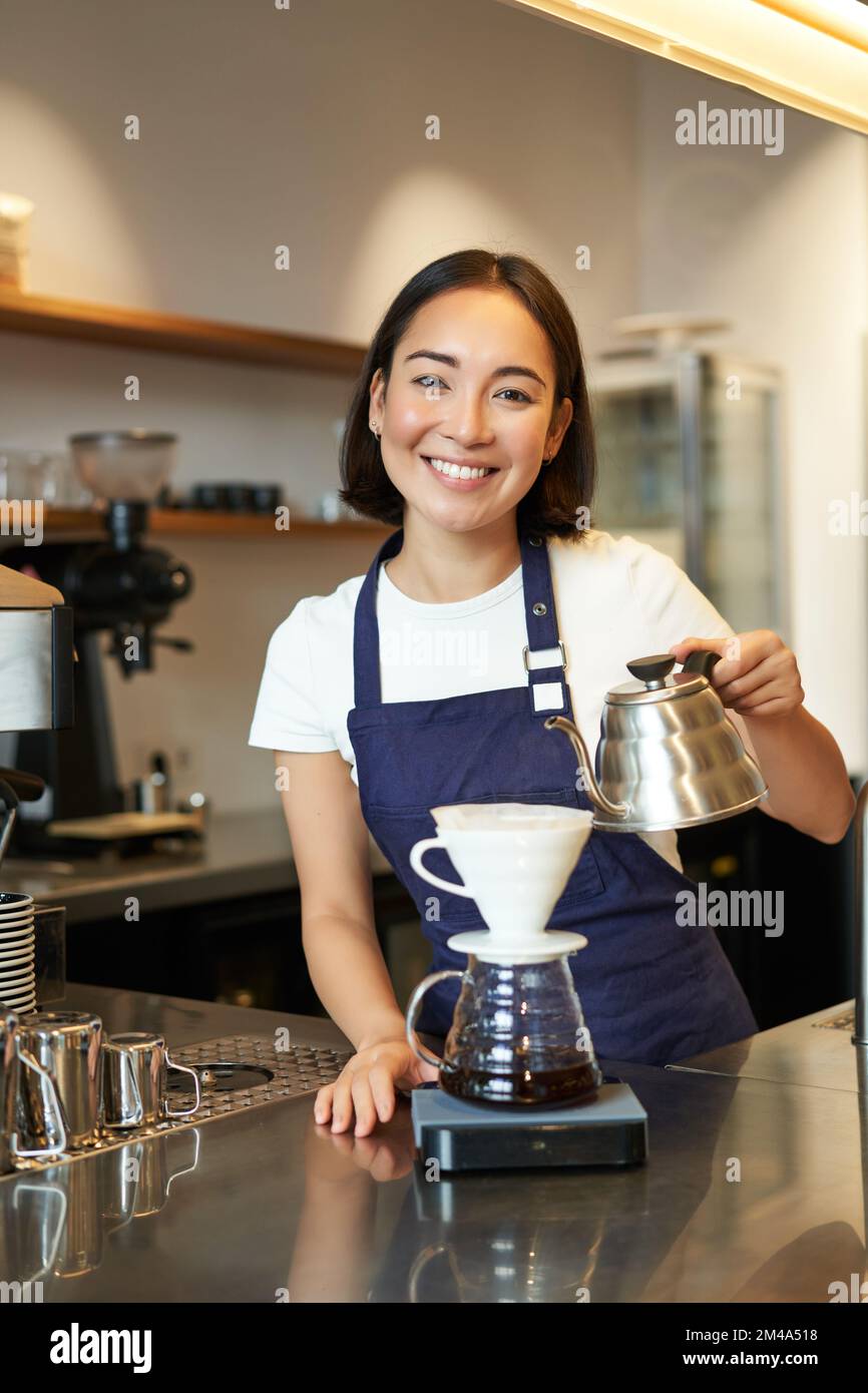 Vertical shot of cute asian girl barista, student working in coffee ...