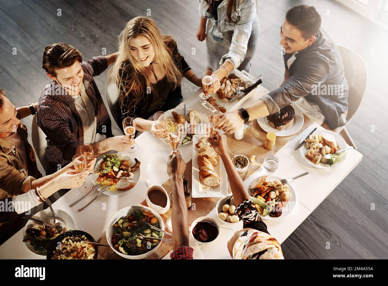 Food brings everyone together. a group of young friends making a toast ...