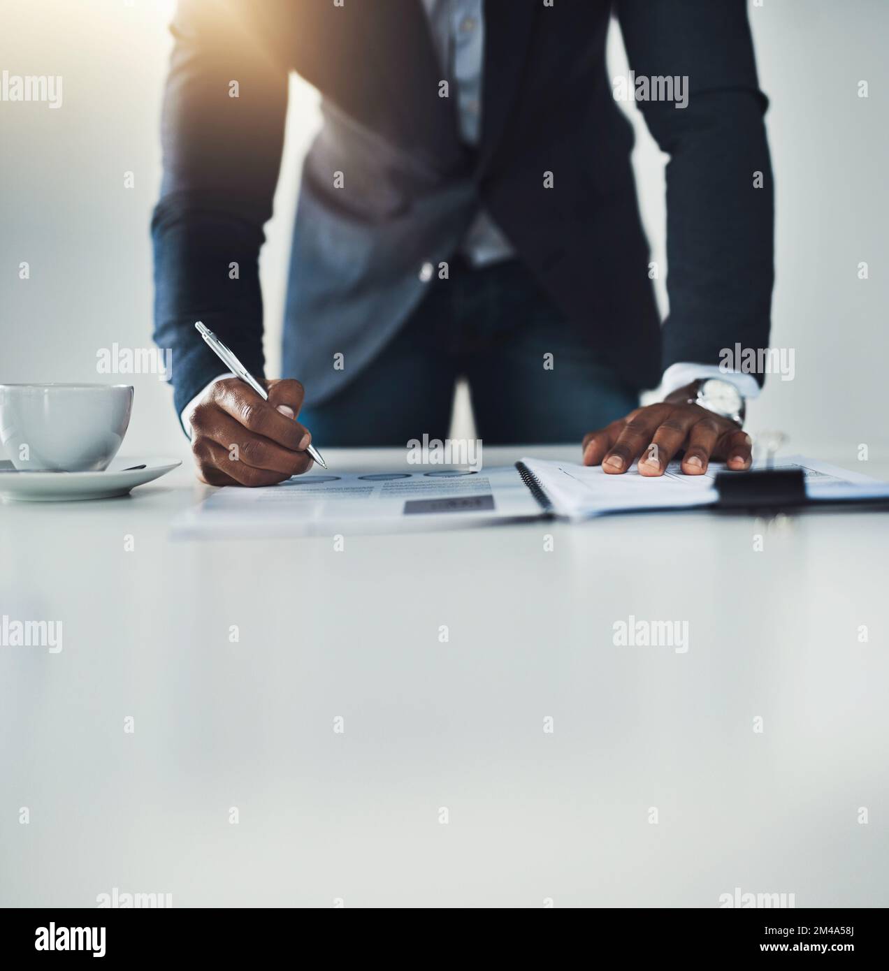 Making some notes. an unrecognizable young businessman taking notes ...