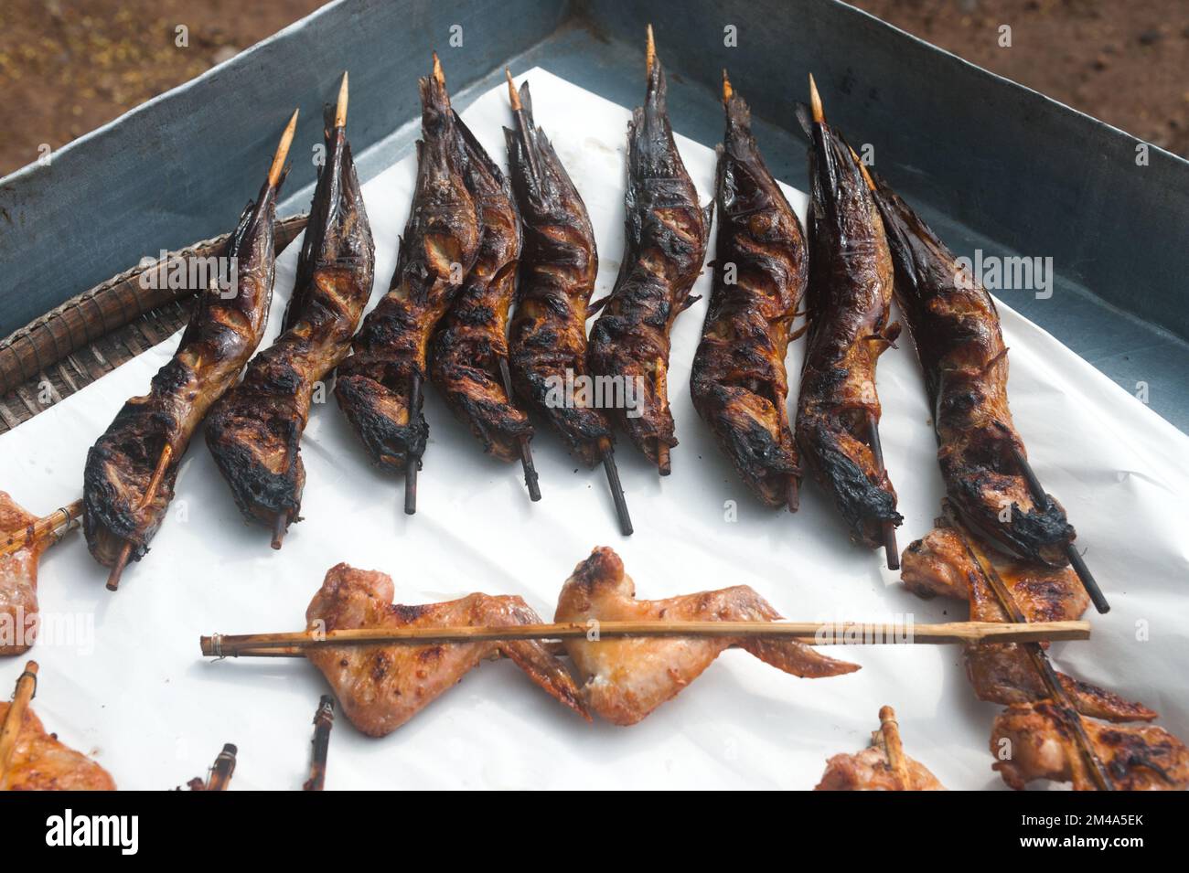 Grilled fish and roast chicken on tray Stock Photo - Alamy