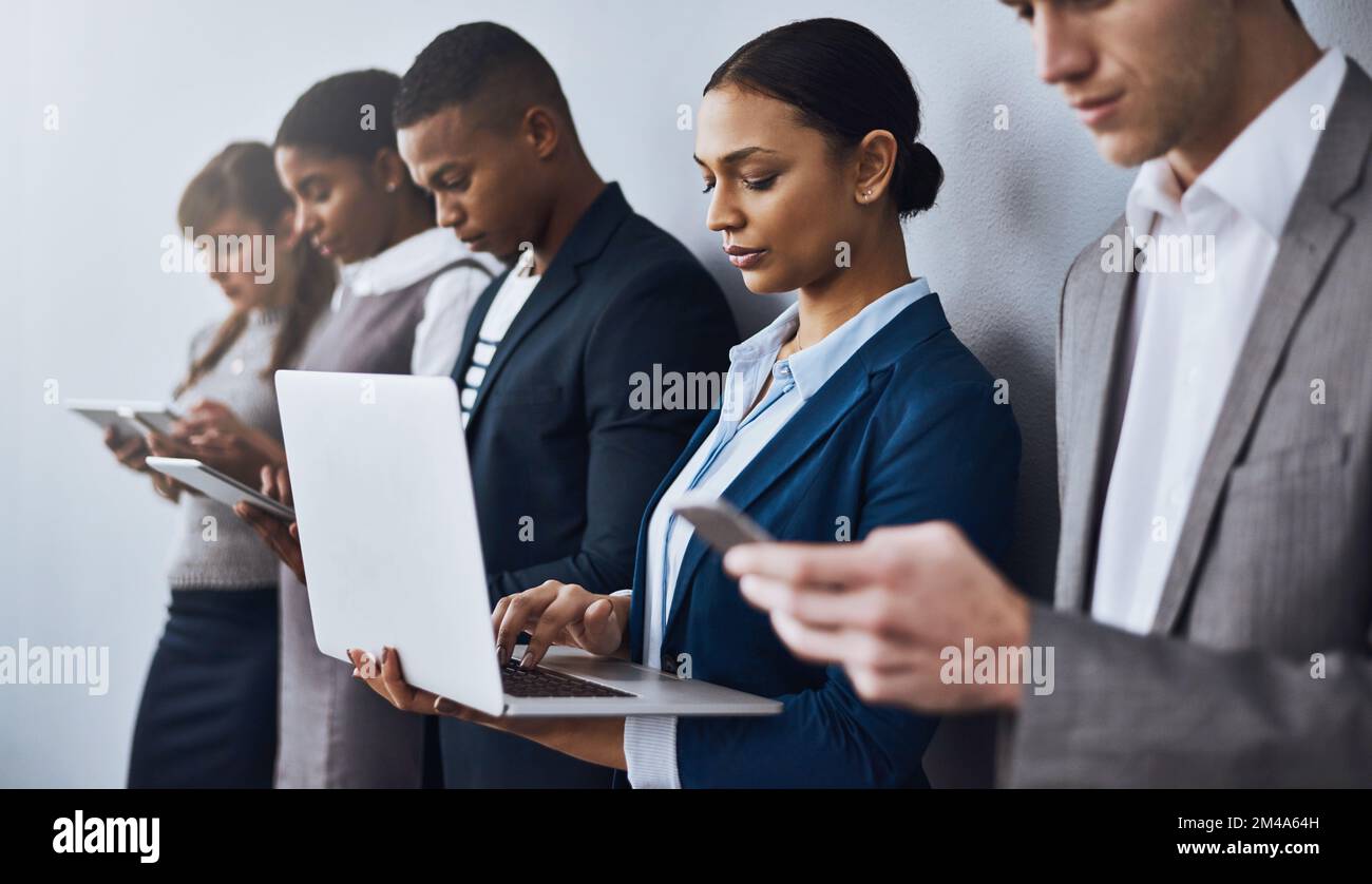 Preparing for their interviews. a group of young businesspeople waiting ...