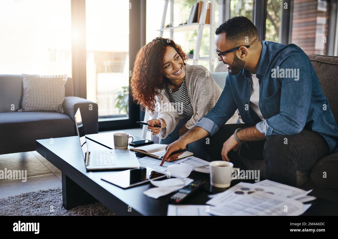 Every cent is recorded in their budget. a young couple planning their ...