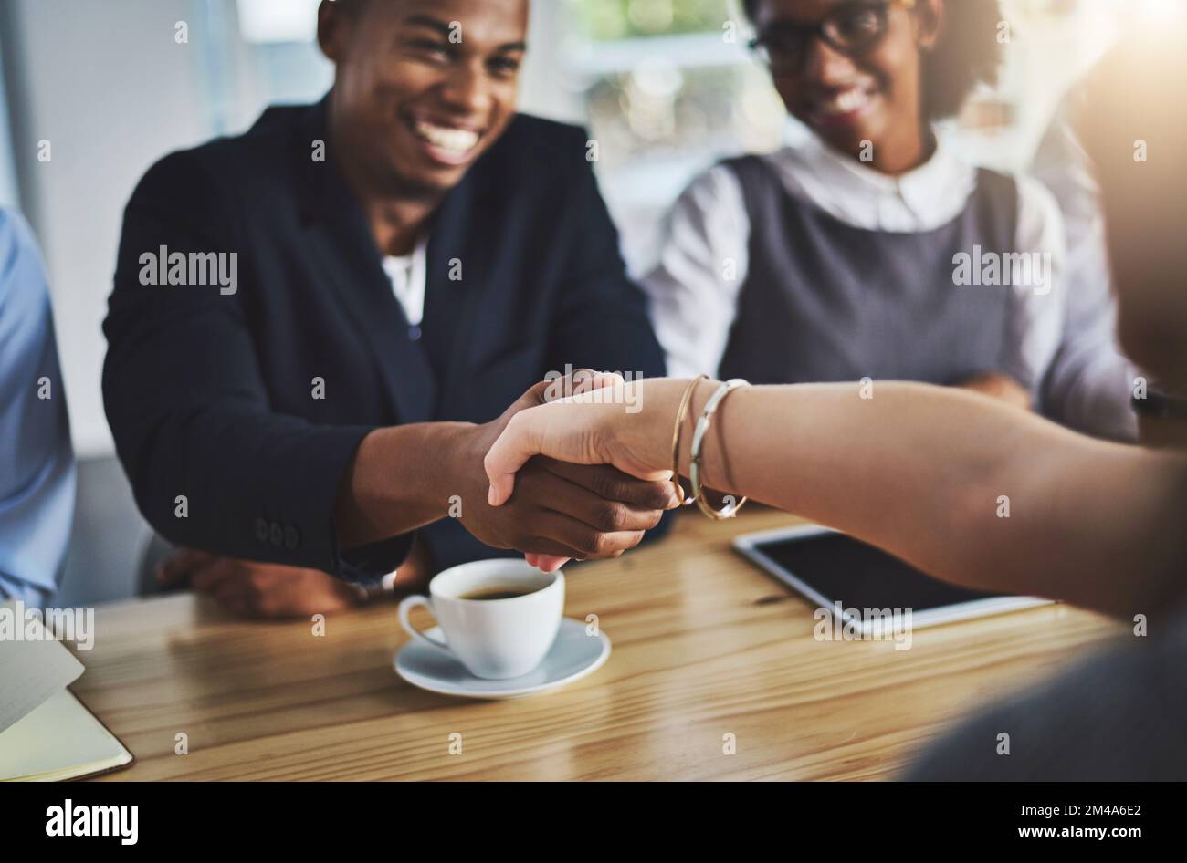 Its nice to finally meet you. two young businesspeople shaking hands ...