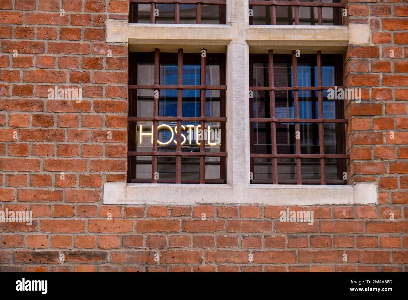 Hostel inscription in neon lights at night. Electric sign at night ...