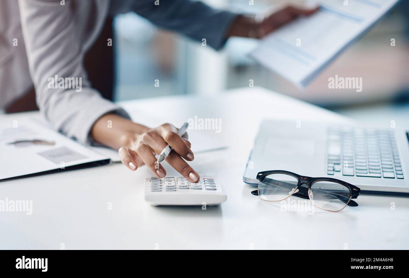 Business is all a numbers game. a businesswoman using a calculator at ...