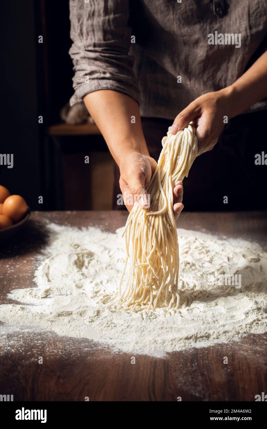 Wheat noodles hand hi-res stock photography and images - Alamy