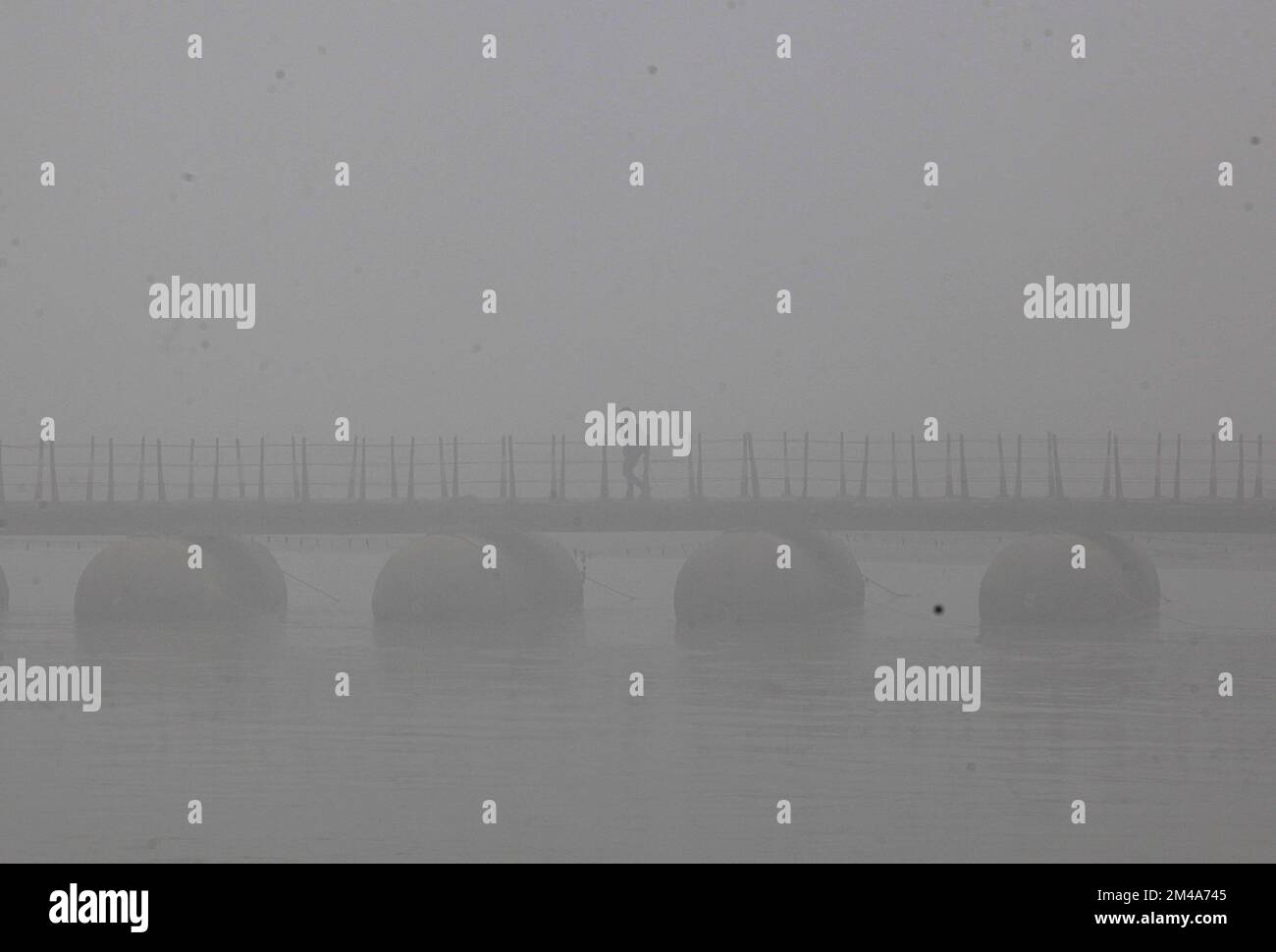Prayagraj, India. 20/12/2022, An Indian man walks on a pontoon bridge ...