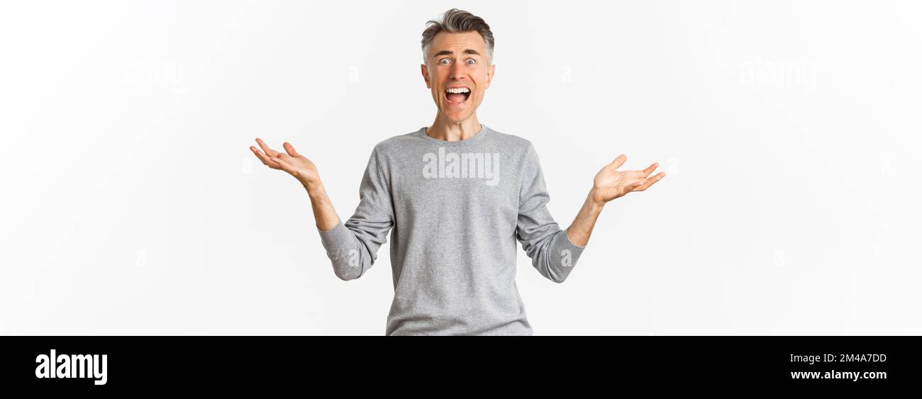 Image of shocked and frustrated man spread hands sideways, shouting and ...