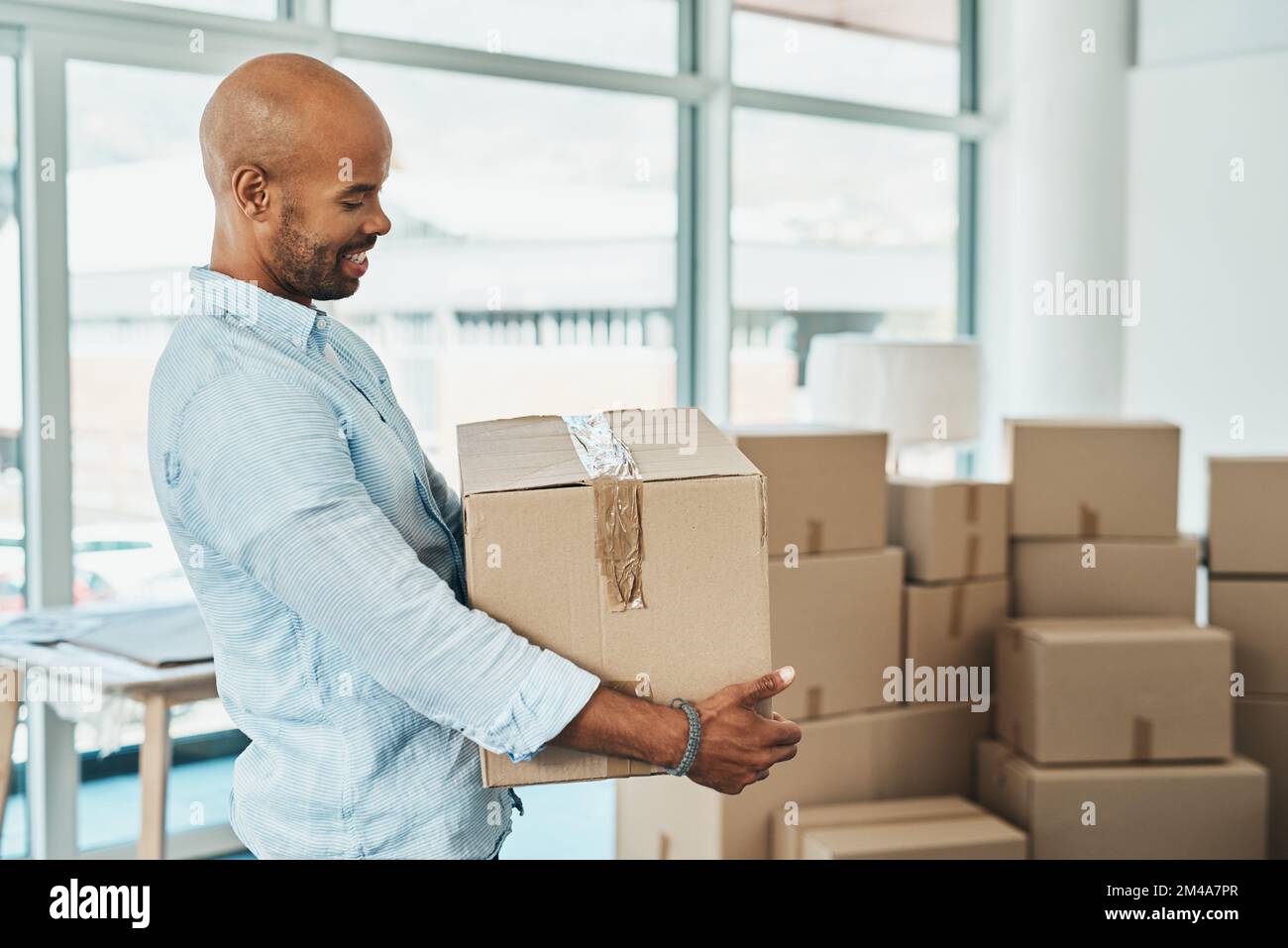 I cant wait to get all of these unpacked. a young man carrying a box ...