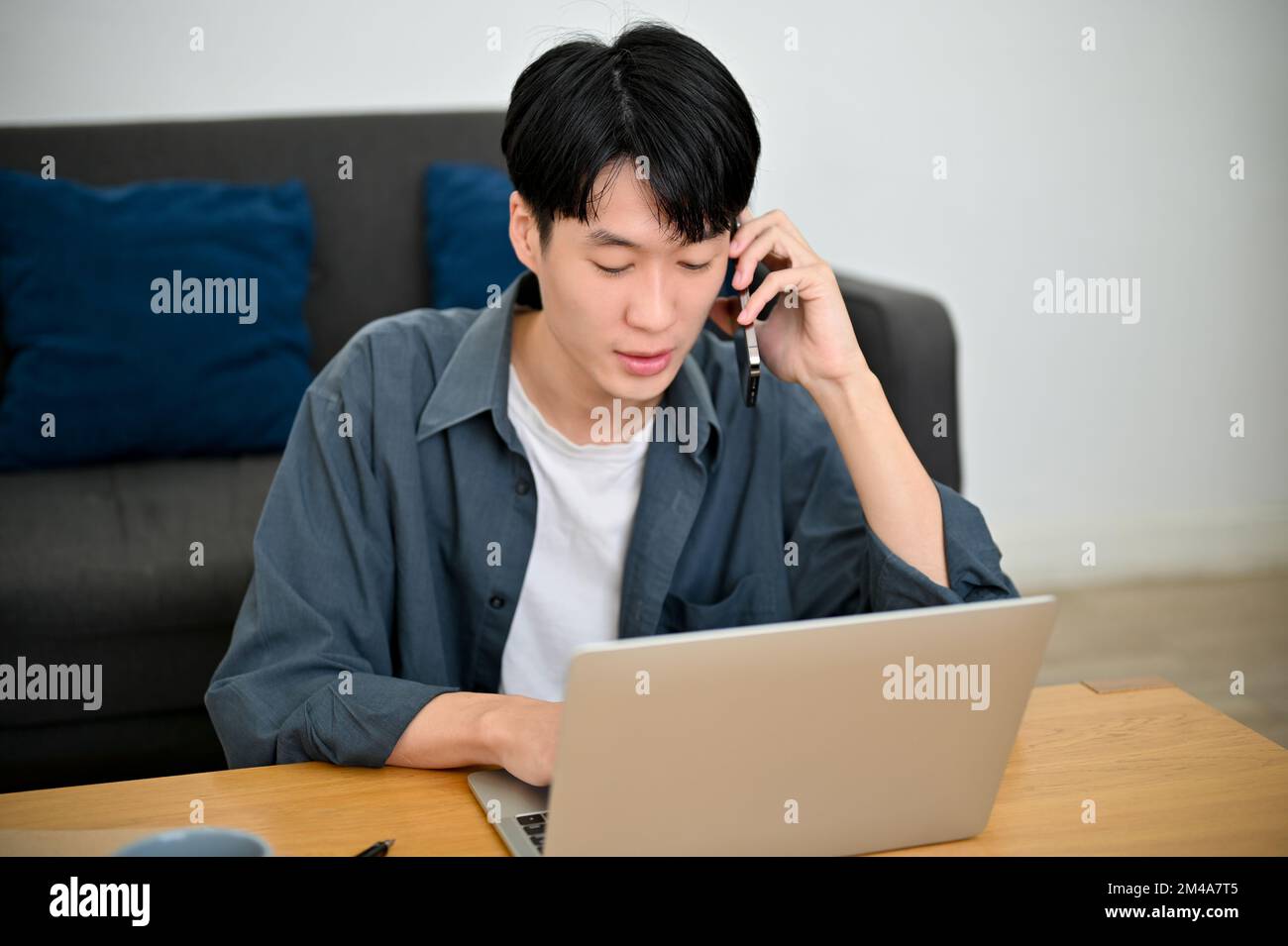 Concentrated asian guy talking hi-res stock photography and images - Alamy