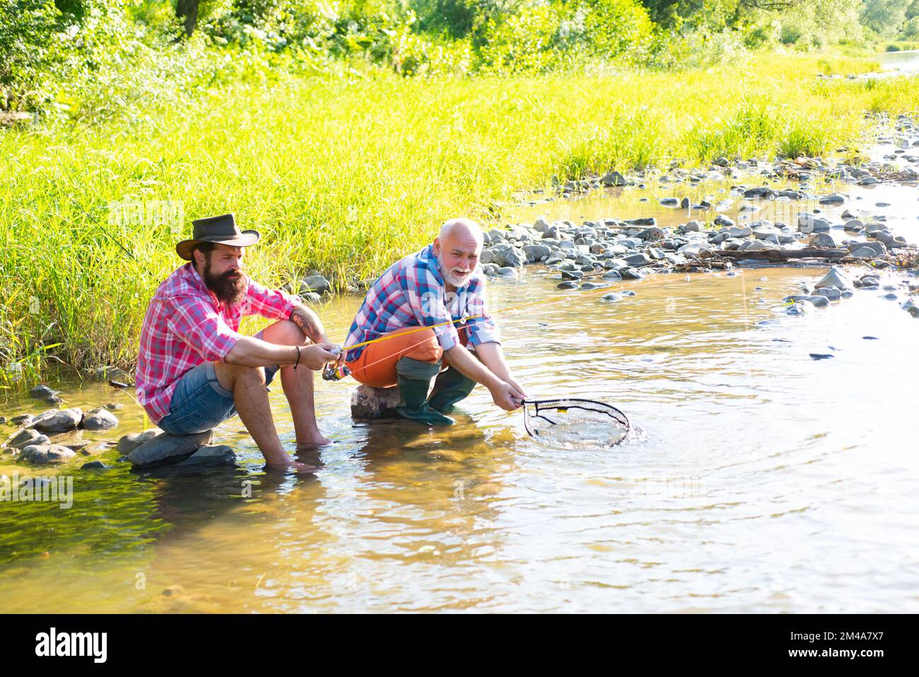 Fisherman men friends and trophy trout. Father and son fishing ...