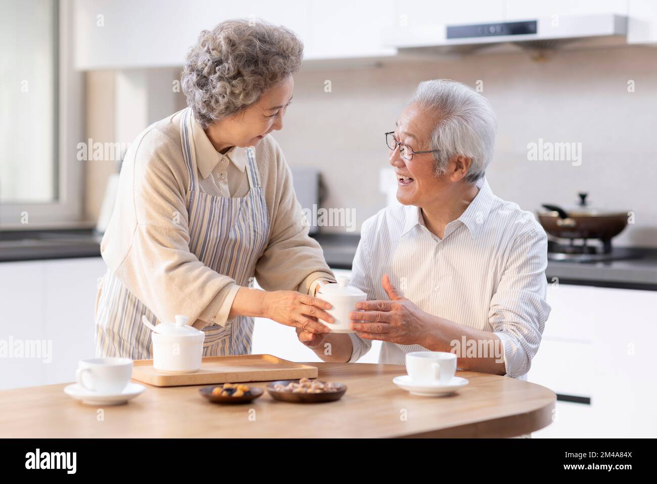 Happy senior Chinese couple having breakfast Stock Photo - Alamy