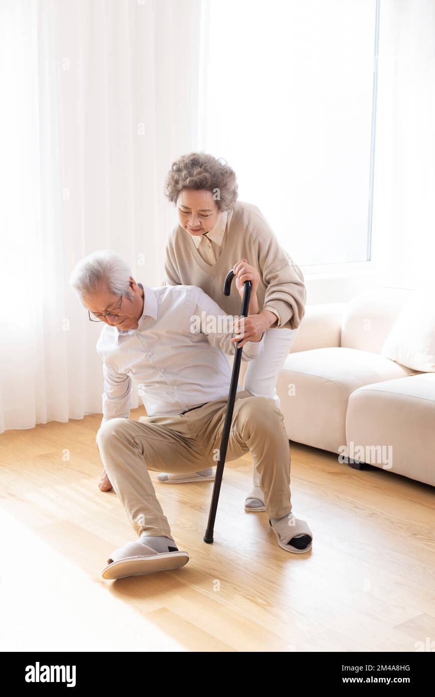 Senior Chinese woman helping her husband to get up Stock Photo - Alamy