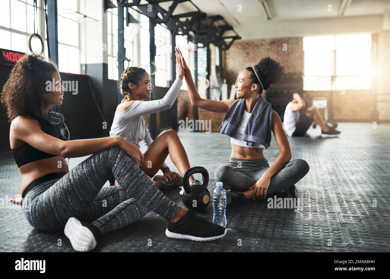 We killed that workout. young women giving each other a high five while ...
