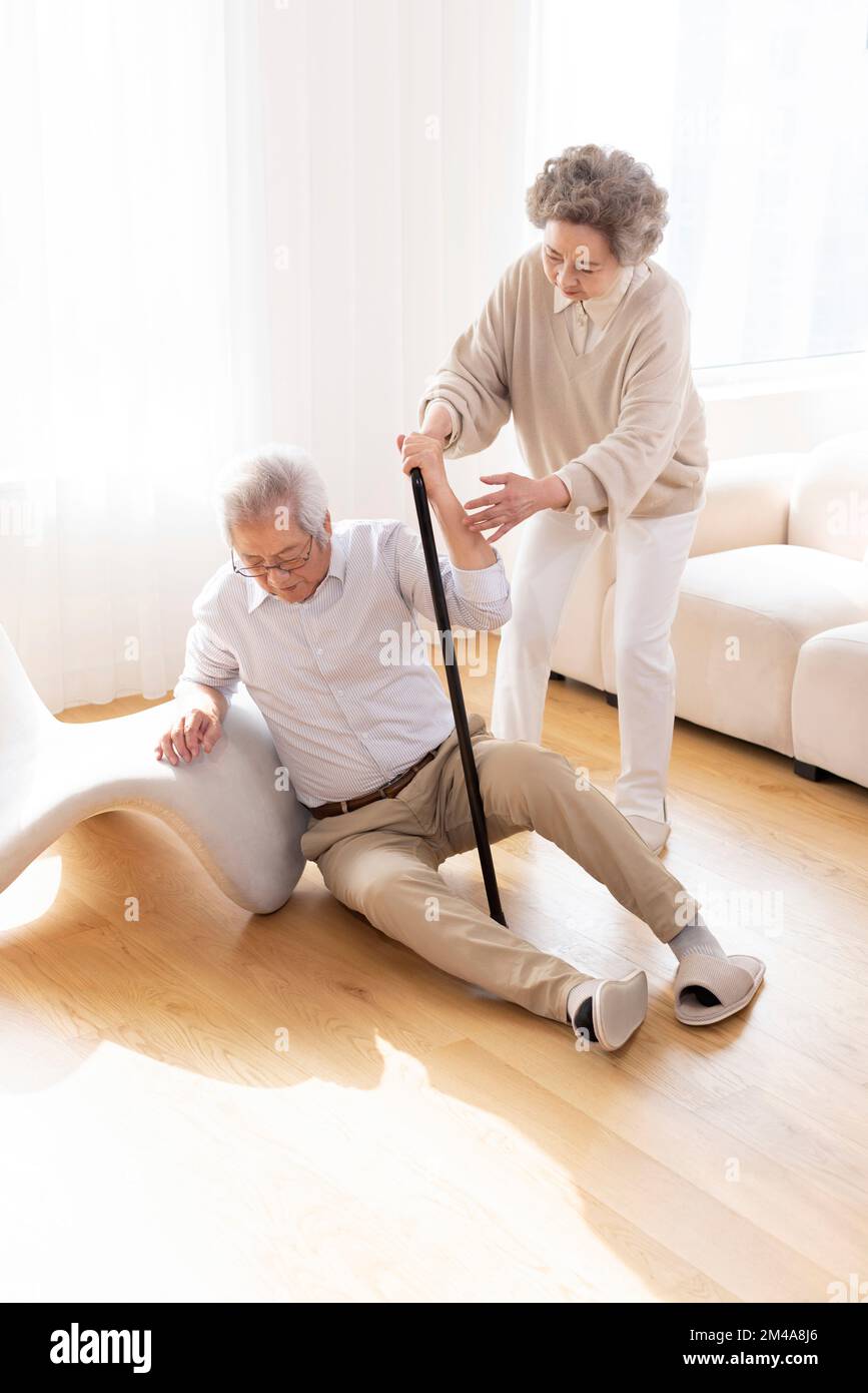 Senior Chinese woman helping her husband to get up Stock Photo - Alamy