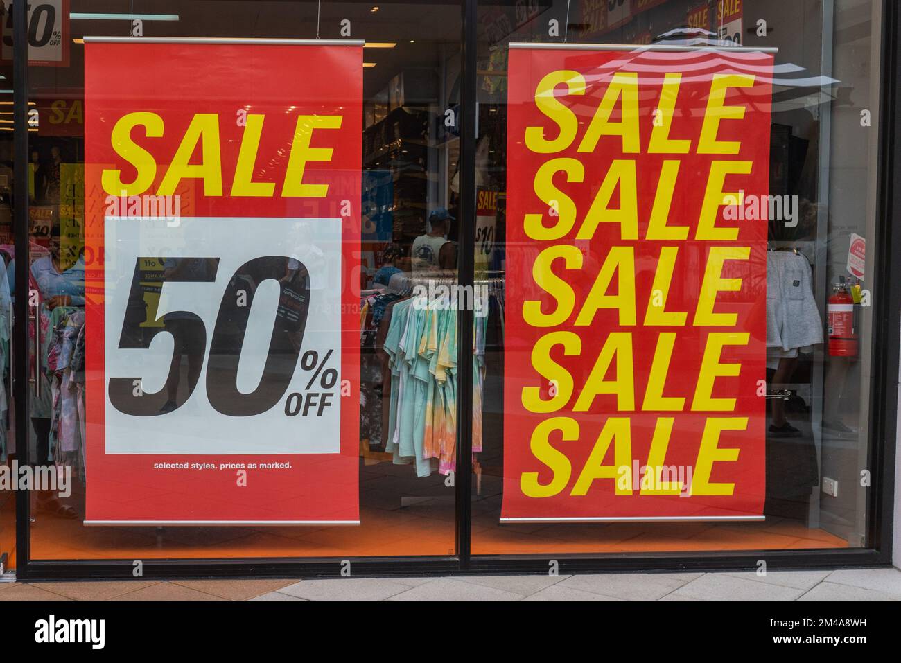 Sale signs in a shop window offering a 50 percent discount Stock Photo ...