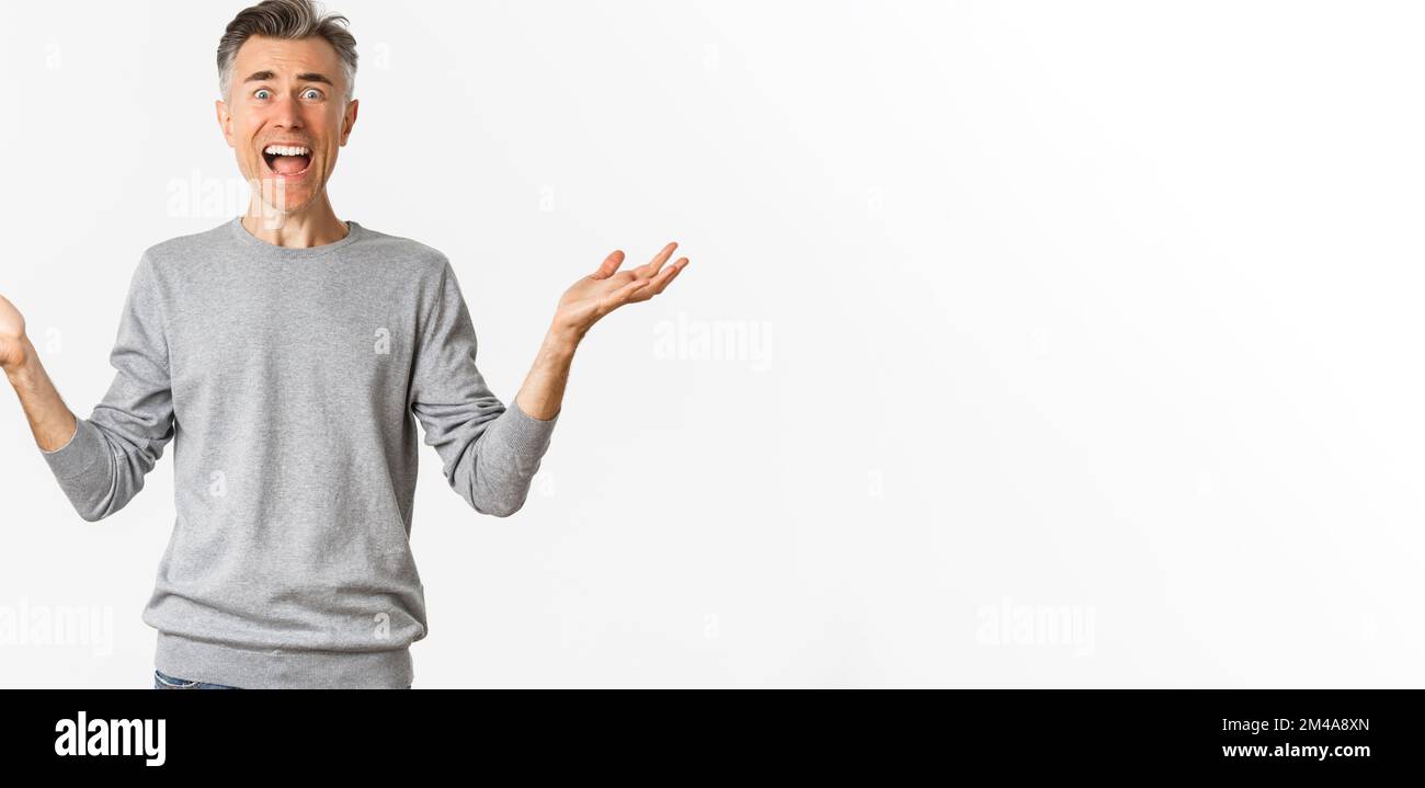 Image of shocked and frustrated man spread hands sideways, shouting and ...